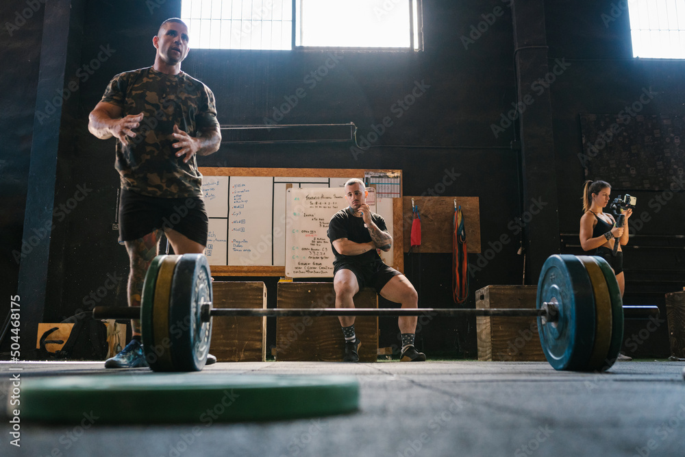 crossfit trainer giving directions in the gym Stock Photo | Adobe Stock