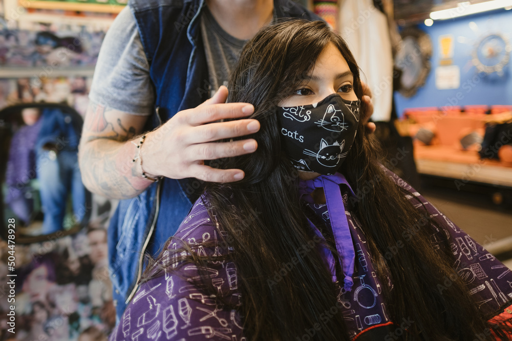 Cute teen girl getting a haircut in a beauty salon Stock Photo | Adobe ...
