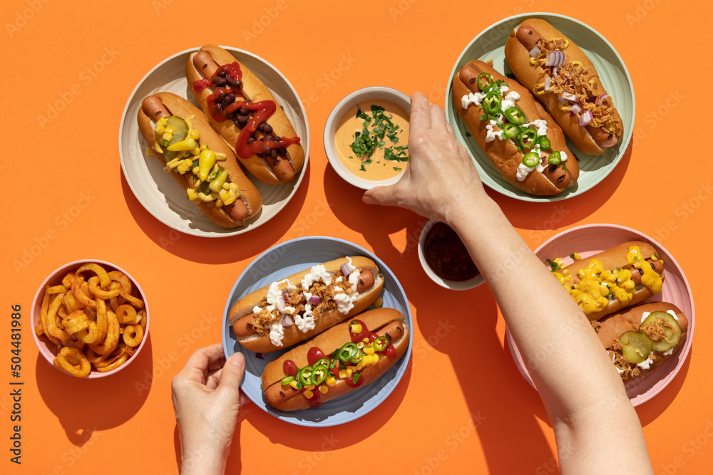 Finger food: grilled hot dogs with condiments and toppings Stock Photo ...