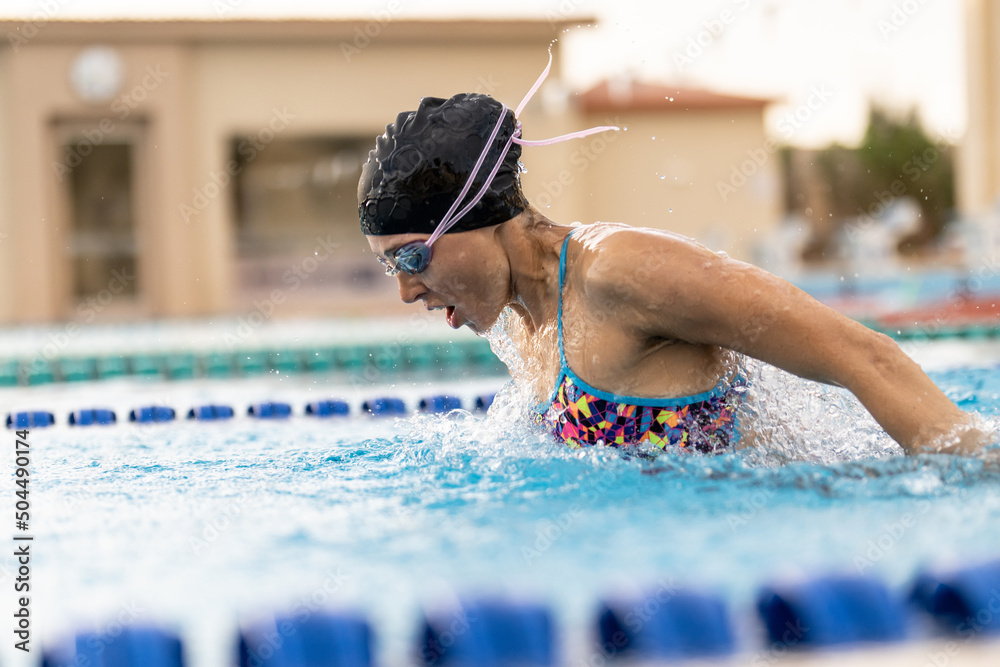 Girl is swimming in outdoor pool during her training Stock Photo ...