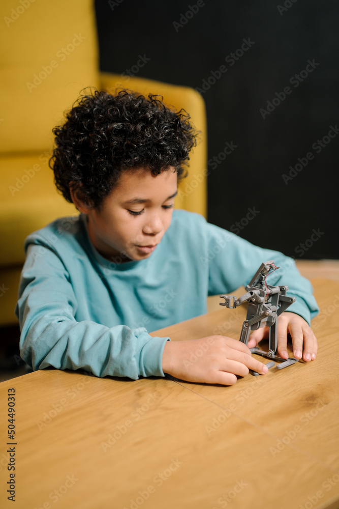 Boy plays with robot toy Stock Photo | Adobe Stock