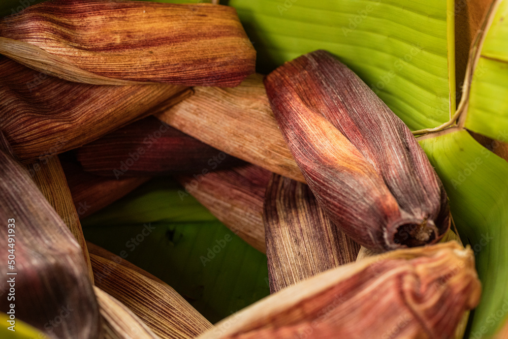tamales stacked inside a container with banana leaves Stock Photo ...