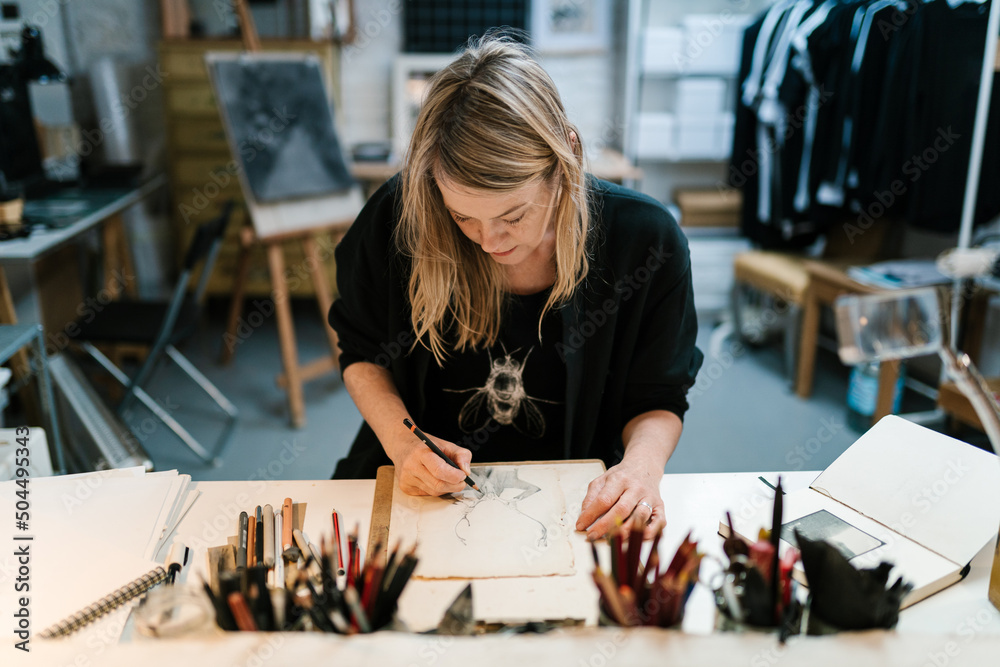 Mature woman drawing in studio Stock Photo | Adobe Stock