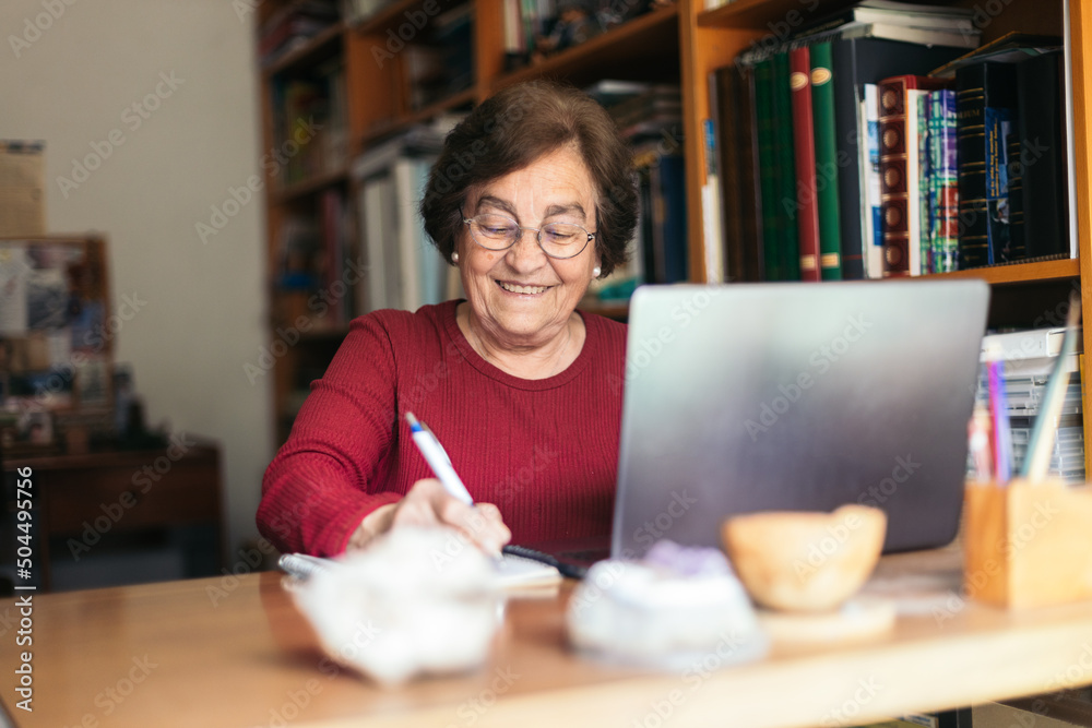 Old woman using laptop Stock Photo | Adobe Stock