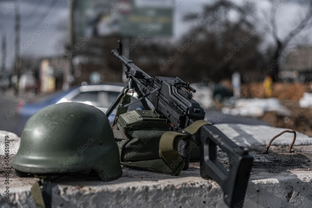 Protective helmet and machine gun on concrete block Stock Photo | Adobe ...