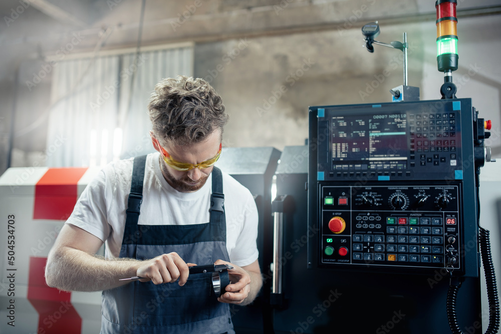 Engineer man work on CNC machine at automatic factory floor. Concept ...