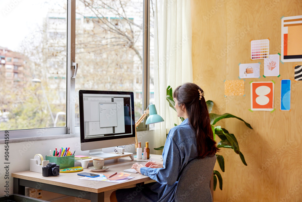 Female designer using software on computer Stock Photo | Adobe Stock