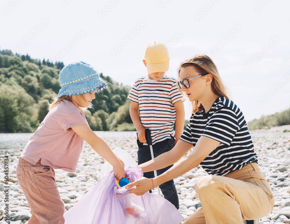 Volunteers family collecting plastic waste trash on river beach. People ...