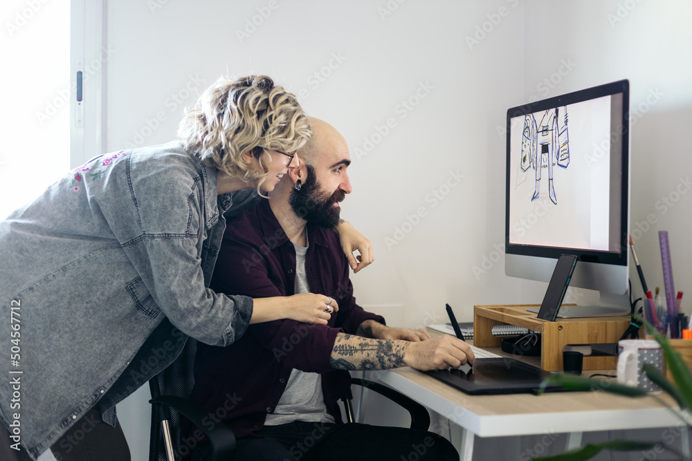 Graphic designer showing his work to his girlfriend Stock Photo | Adobe ...