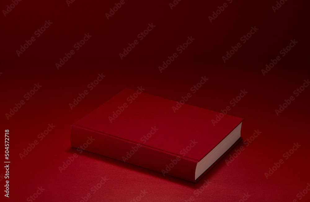 Solid red book on red background Stock Photo | Adobe Stock