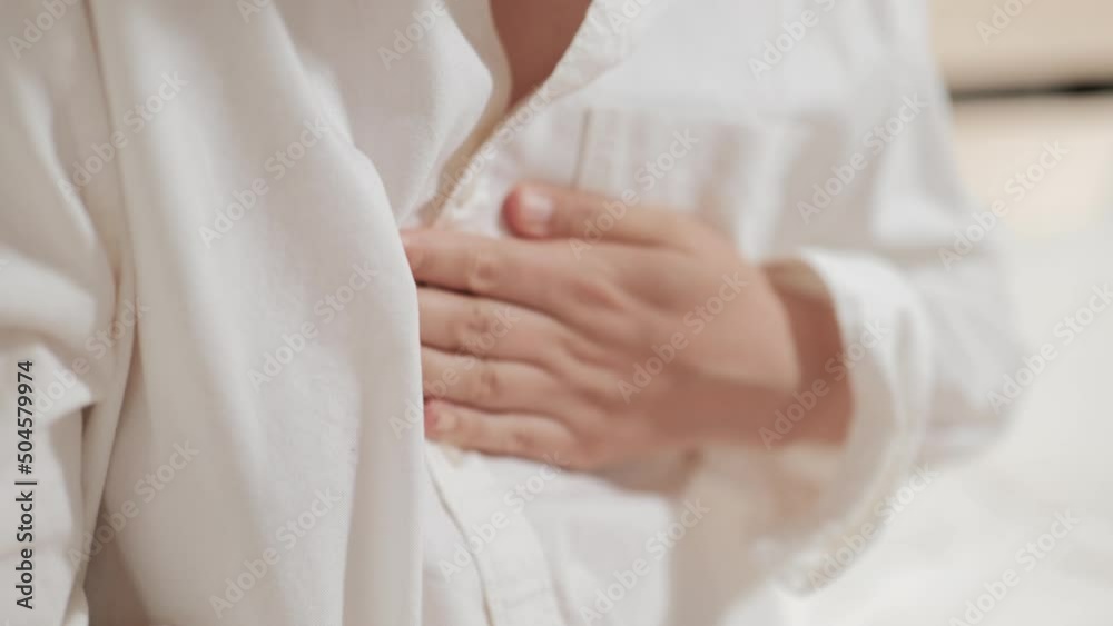 Chest pain, heart attack. Suffering woman with chest pain. Close-up of ...