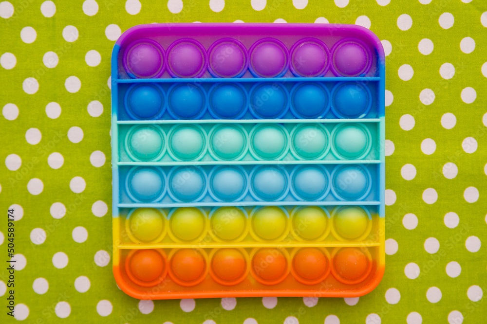 Sensory fidget toy "Pop-it". Instrument for fine motoric skils, tool to ...