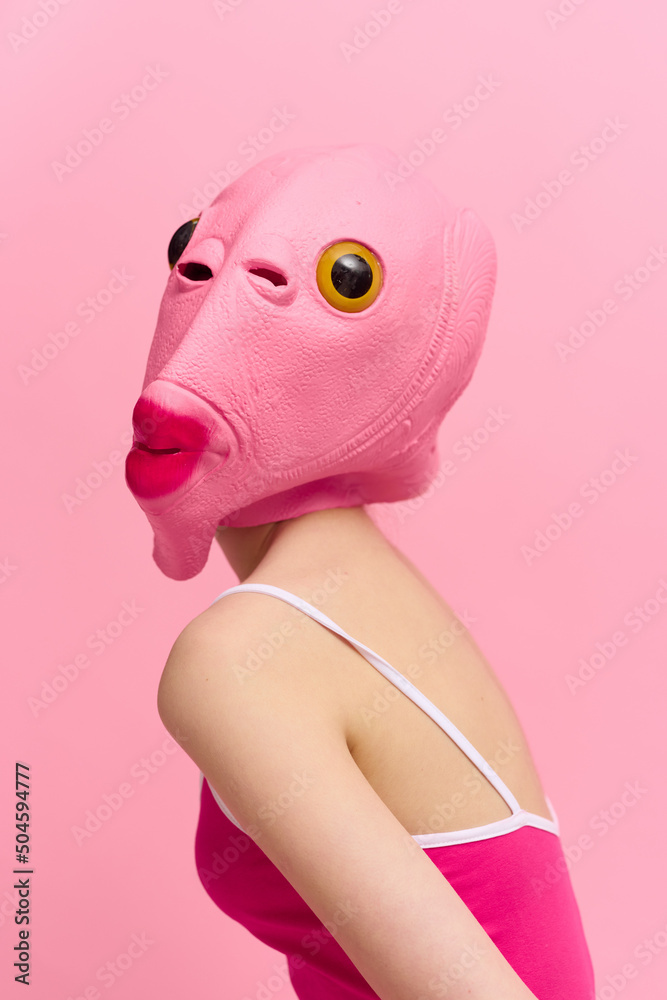 Skinny woman in a pink Halloween costume with a fish head on her face ...