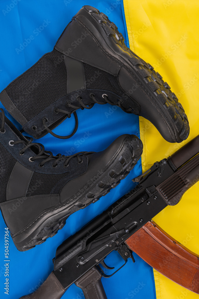 Leather tactical army boots with a Kalashnikov assault rifle lie on the ...
