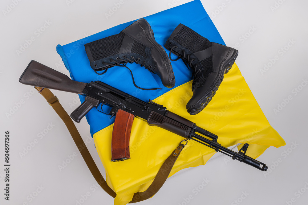Leather tactical army boots with a Kalashnikov assault rifle lie on the ...
