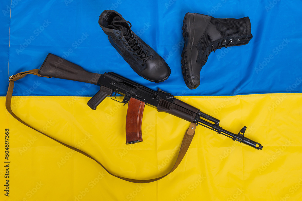 Leather tactical army boots with a Kalashnikov assault rifle lie on the ...