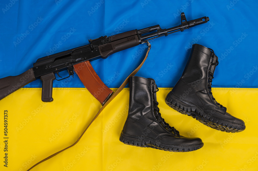 Leather tactical army boots with a Kalashnikov assault rifle lie on the ...
