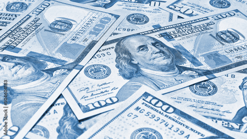 American paper money. 100 dollar and other US notes. Light blue tinted ...