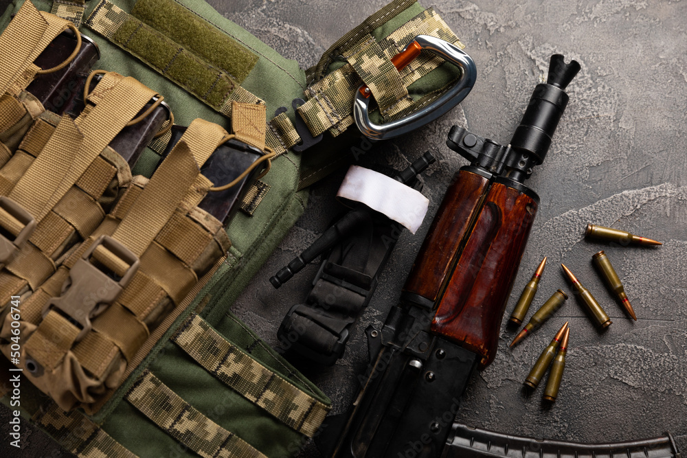 Military body armor, helmet and ammunition, a Kalashnikov assault rifle ...