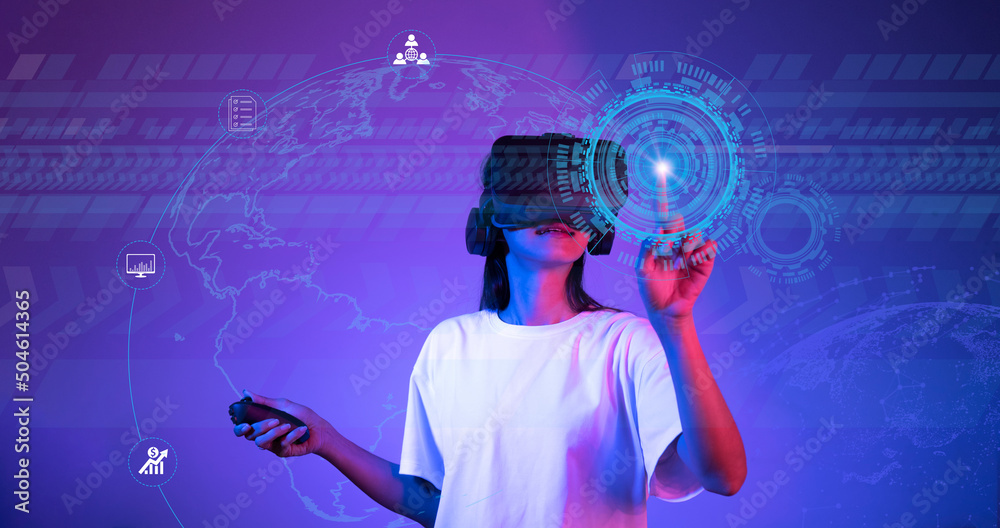 Young Asian woman is roaming the virtual world wearing VR glasses ...