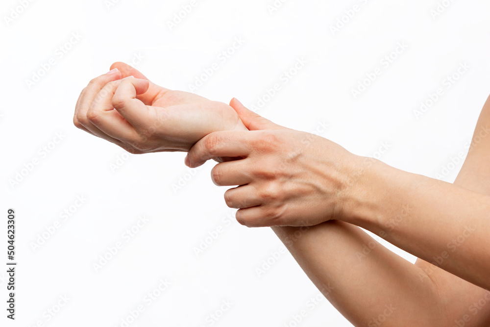 Cropped shot of a young woman holding a wrist in her hand isolated on a ...