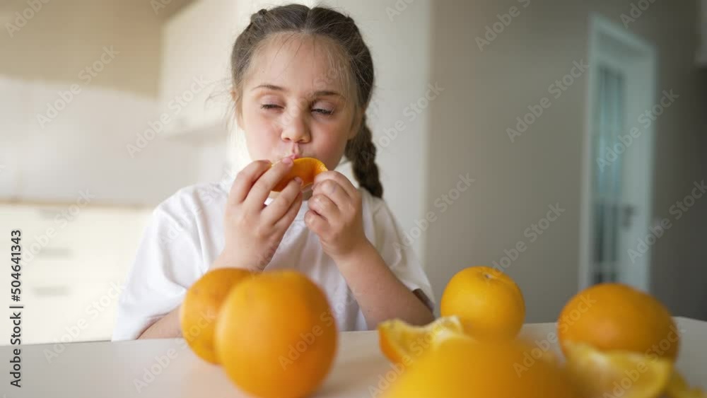 girl child eating oranges. happy family fruit healthy food kid concept. little girl daughter ...