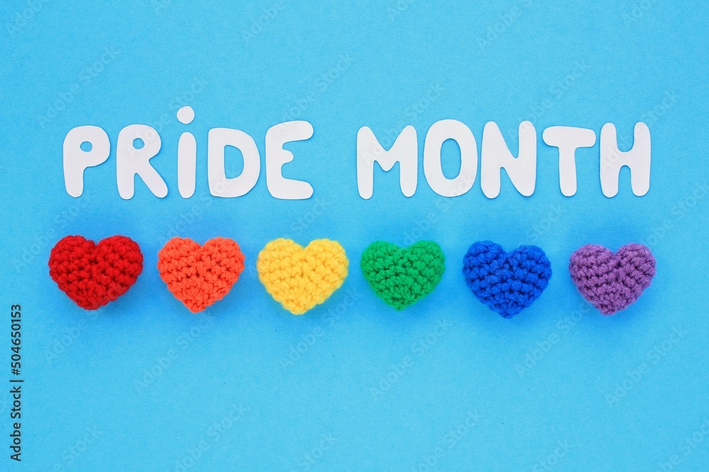 Crochet hearts rainbow colors and Pride Month lettering on blue ...