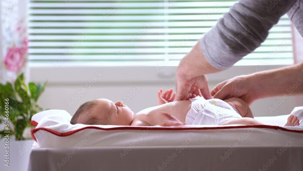 Middle age father changing diaper for newborn baby. Male parent taking ...