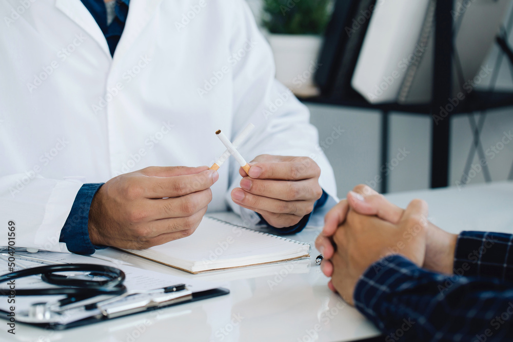 World No Tobacco Day. a doctor holds cigarettes together in the shape ...