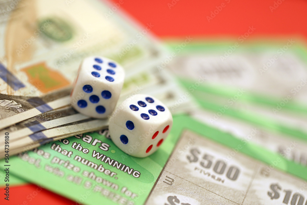 Close up view of green lottery scratch cards with us dollar bills and ...