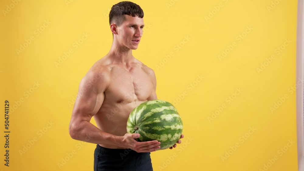 athlete sportsman lifting heavy watermelon for triceps muscles on ...