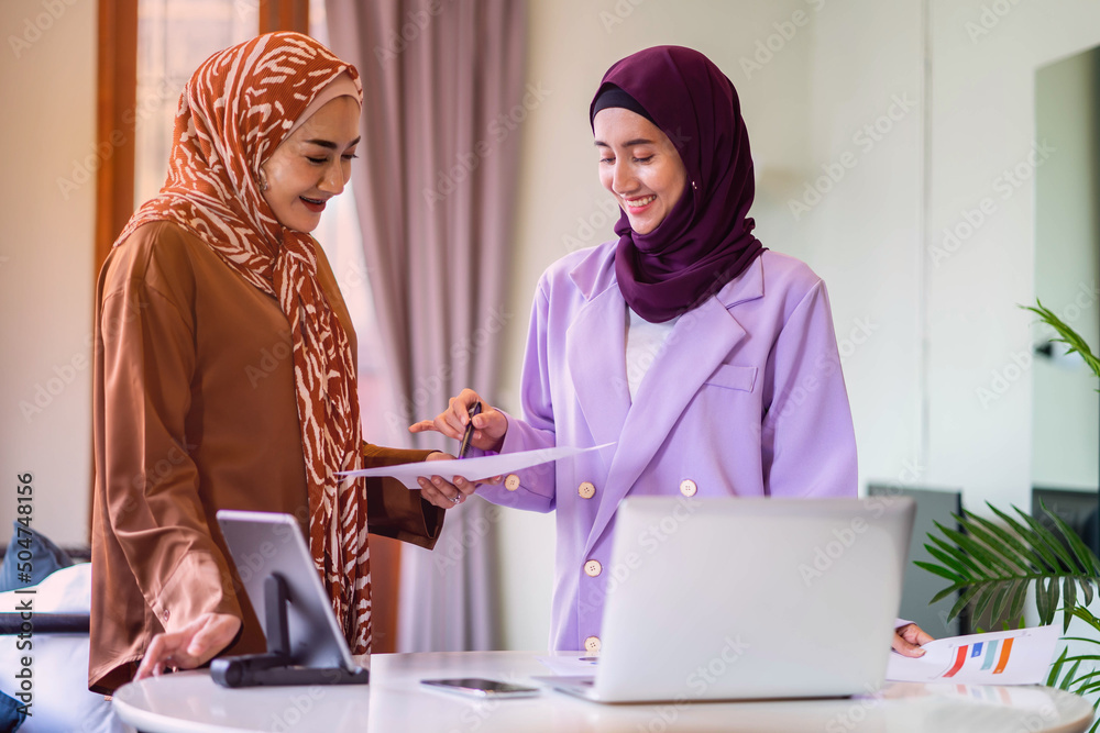 Muslim Businesswoman and partner hands holding pointing graph chart and ...
