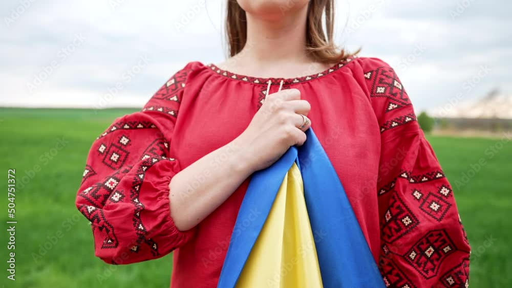 Ukrainian Woman Holding National Flag Over Her Heart During Anthem Ukrainian Woman Holding National Flag Over Her Heart During Anthem