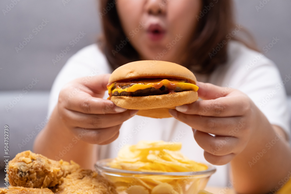Young Asian oversize women gain weight while eating hamburger fried ...
