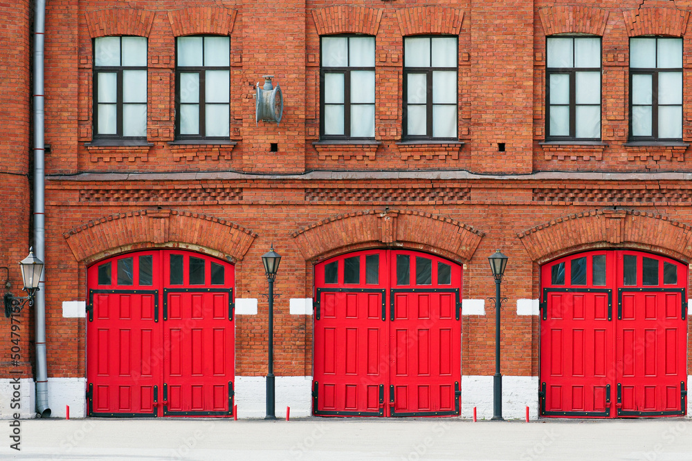 Foto de Fire station, an old historic brick building with red gates ...
