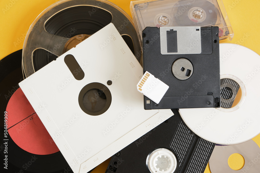 different types of storage media from the last century against a yellow ... different types of storage media from the last century against a yellow ...