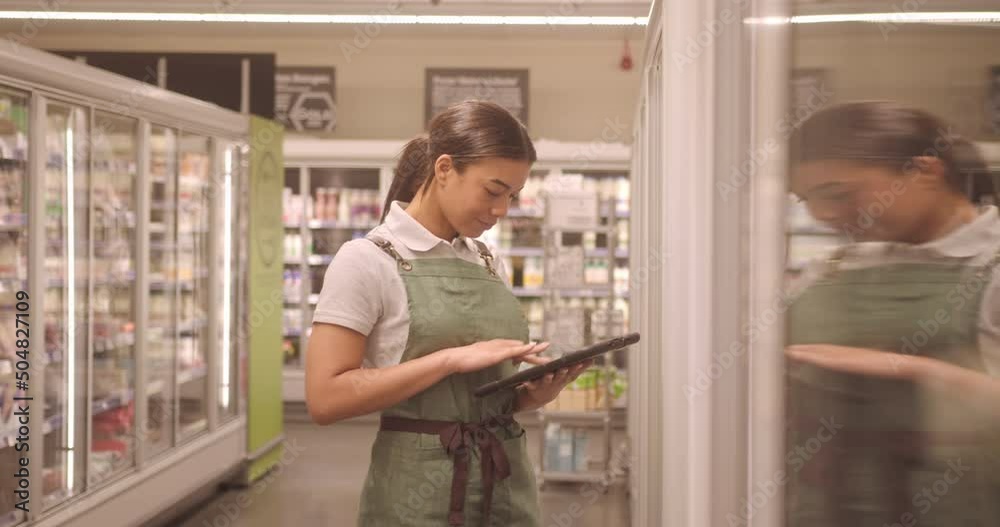Supermarket Employee Taking Inventory Using Digital tablet in Store ...