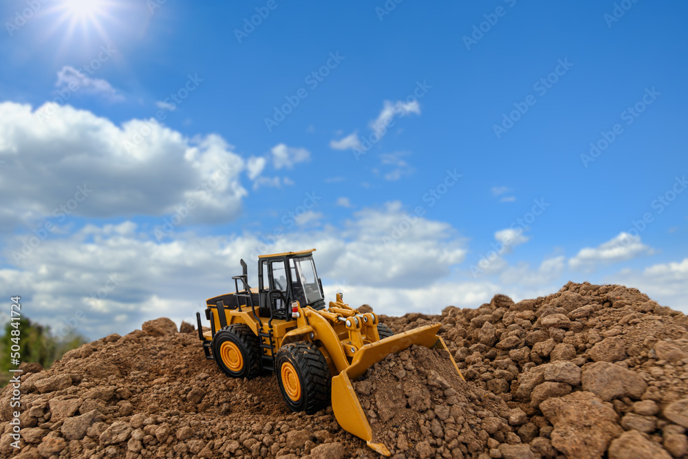 Wheel loader are digging the soil in the construction site on blue sky ...