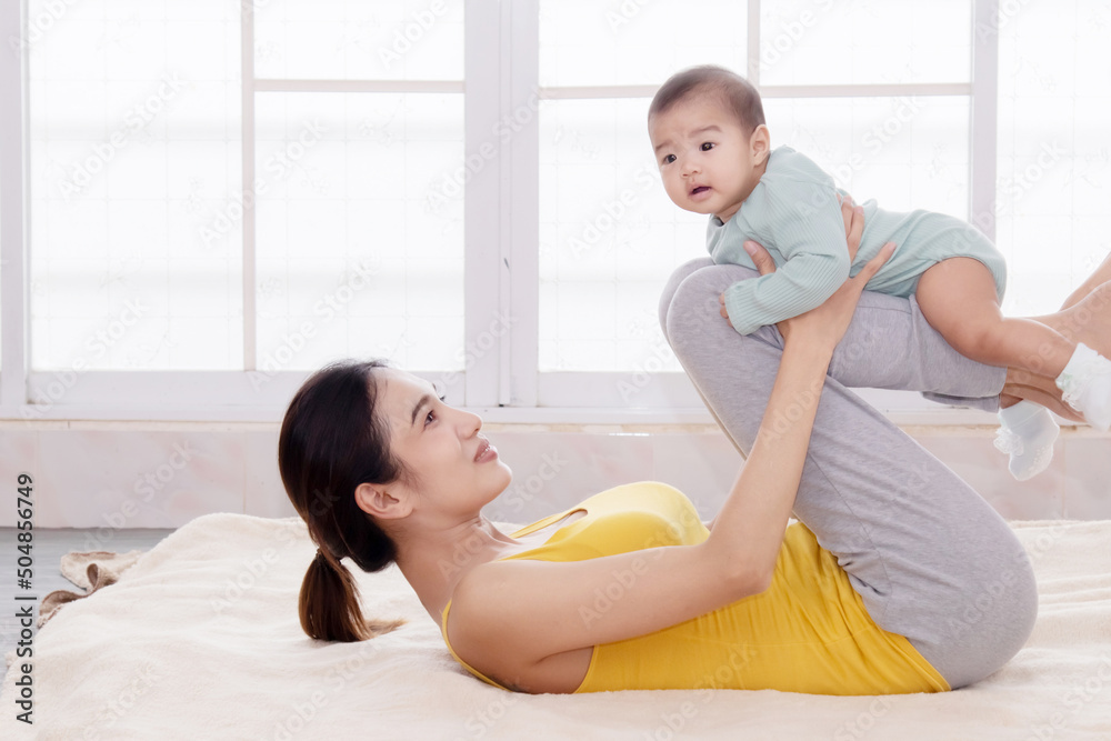 Selective focus Beautiful Asian mother and daughter doing yoga exercise ...