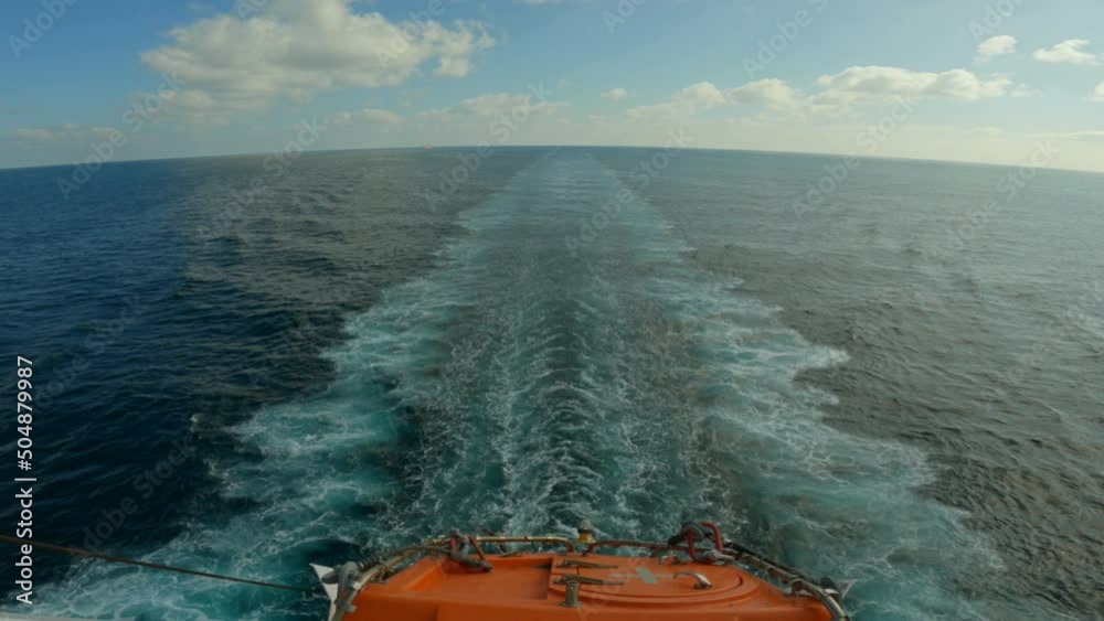 Water trace from ship. Wake of vessel. Back view. Lifeboat in ...