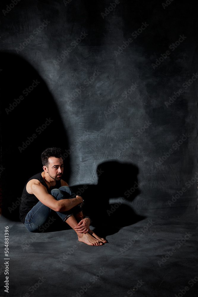 Handsome dark haired man feeling lonely and depressed. Actor playing ...