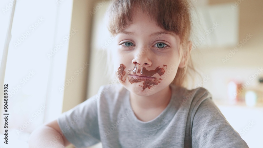 children eat chocolate. dirty little baby kids in the kitchen eating ...