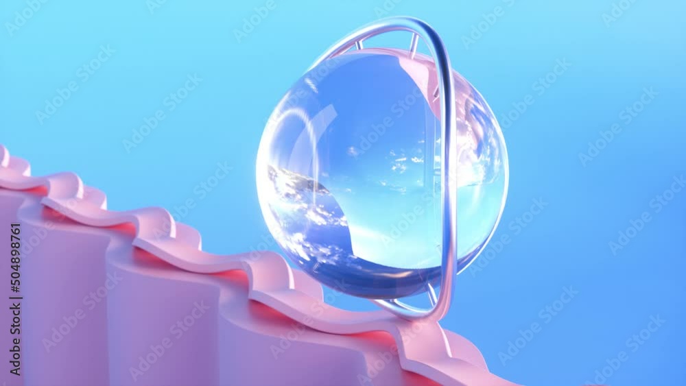 Looped glass ball with metal ring rotating on curved surface ...
