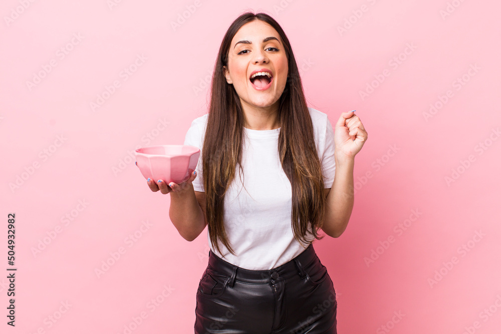 young pretty woman shouting aggressively with an angry expression ...