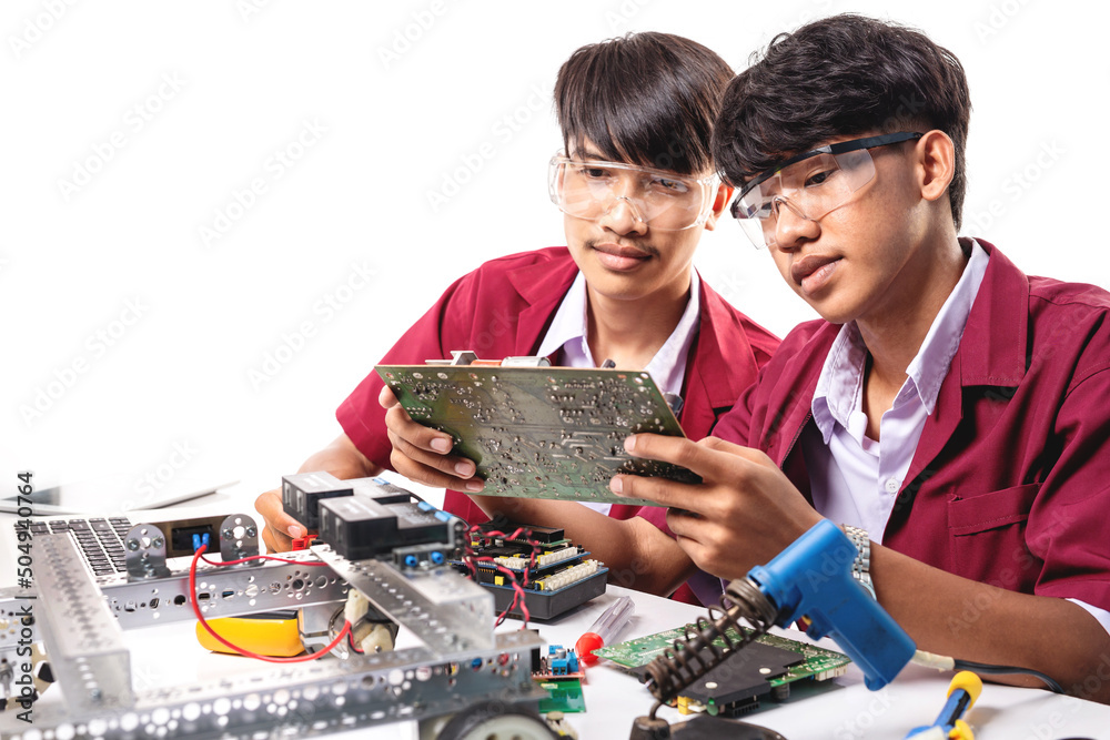 Two teenage Asian college students holding Robot circuit board and ...