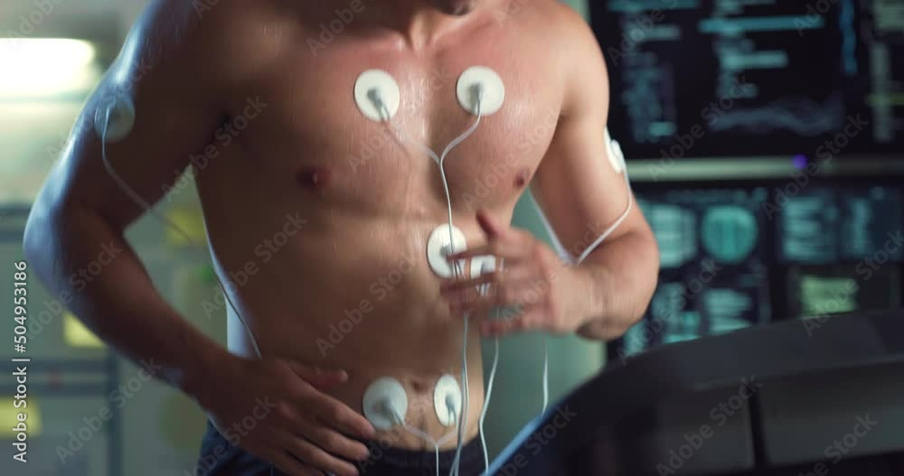 Cinematic close up shot of young athlete with medical electrodes doing ...
