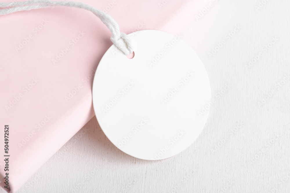 Round white gift tag mockup on pink background. Blank paper circular ...