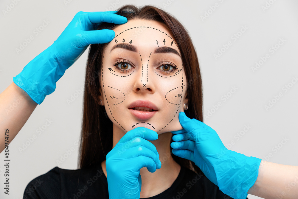 Portrait of a pretty young woman with surgical marks on her face ...