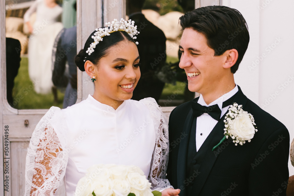 Latina bride and multiracial groom smile together after marriage Stock ...