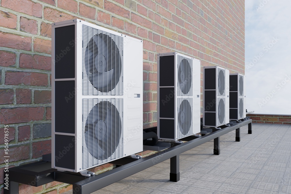 four two-fan outdoor air conditioner units against a brick wall Stock ...